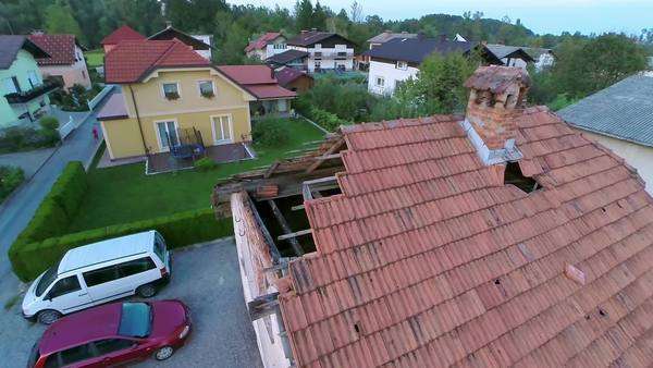 House roof falling apart aerial shot. Aerial shot of old house with ...