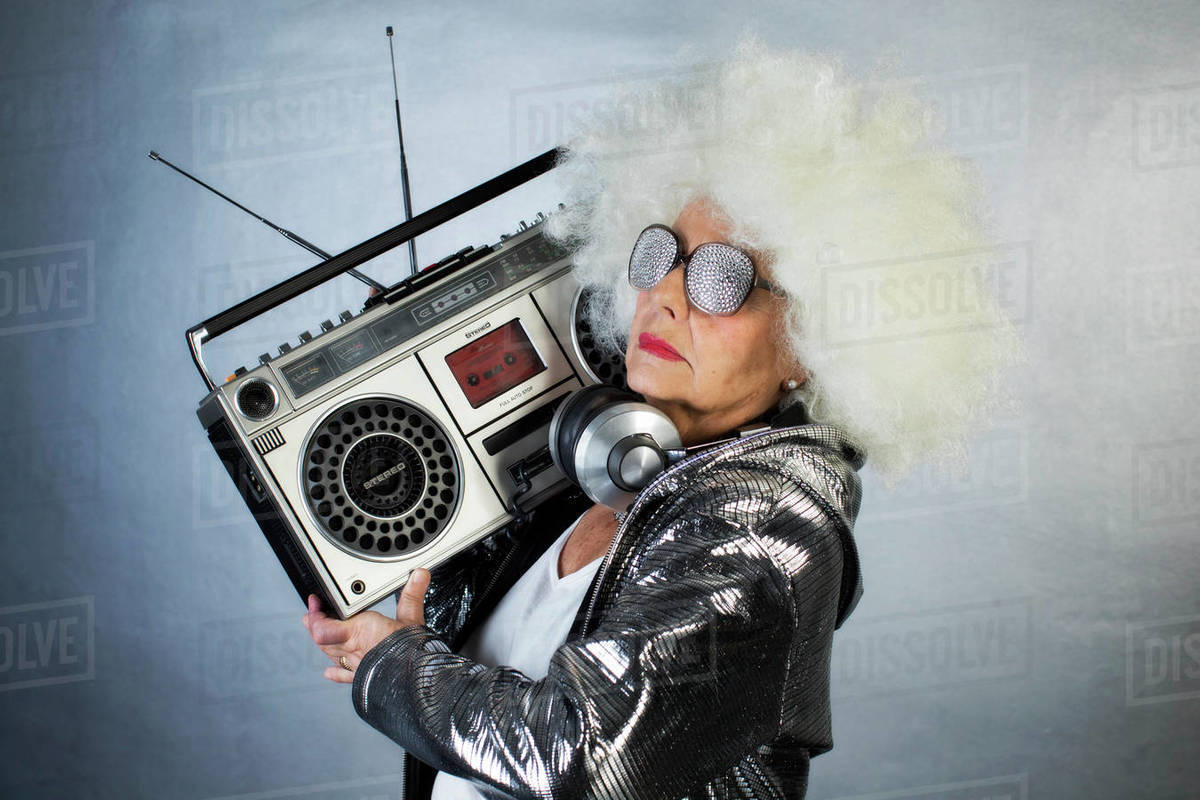 an amazing grandma DJ, older lady with a ghettoblaster, partying in a ...