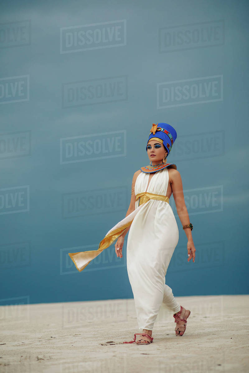 Young woman in image of ancient egyptian queen Nefertiti walks through ...