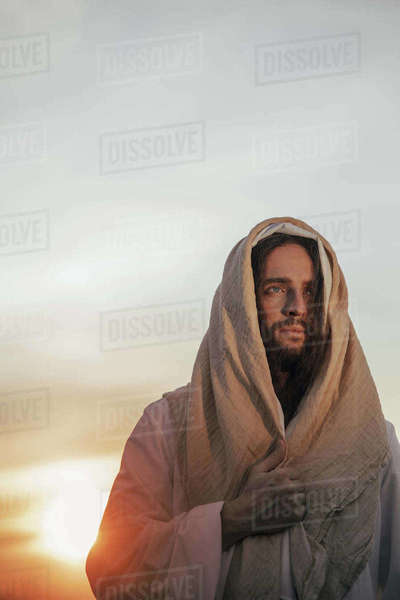 Prophet in his traditional white robe against sunset sky background ...