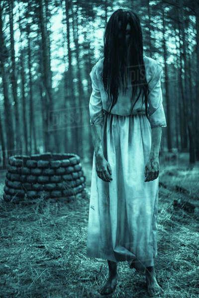 Girl with long black hair in image of scary ghost zombie stands among ...