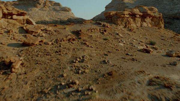 aerial close up shot up side of mountain to rocky formations to edge of ...