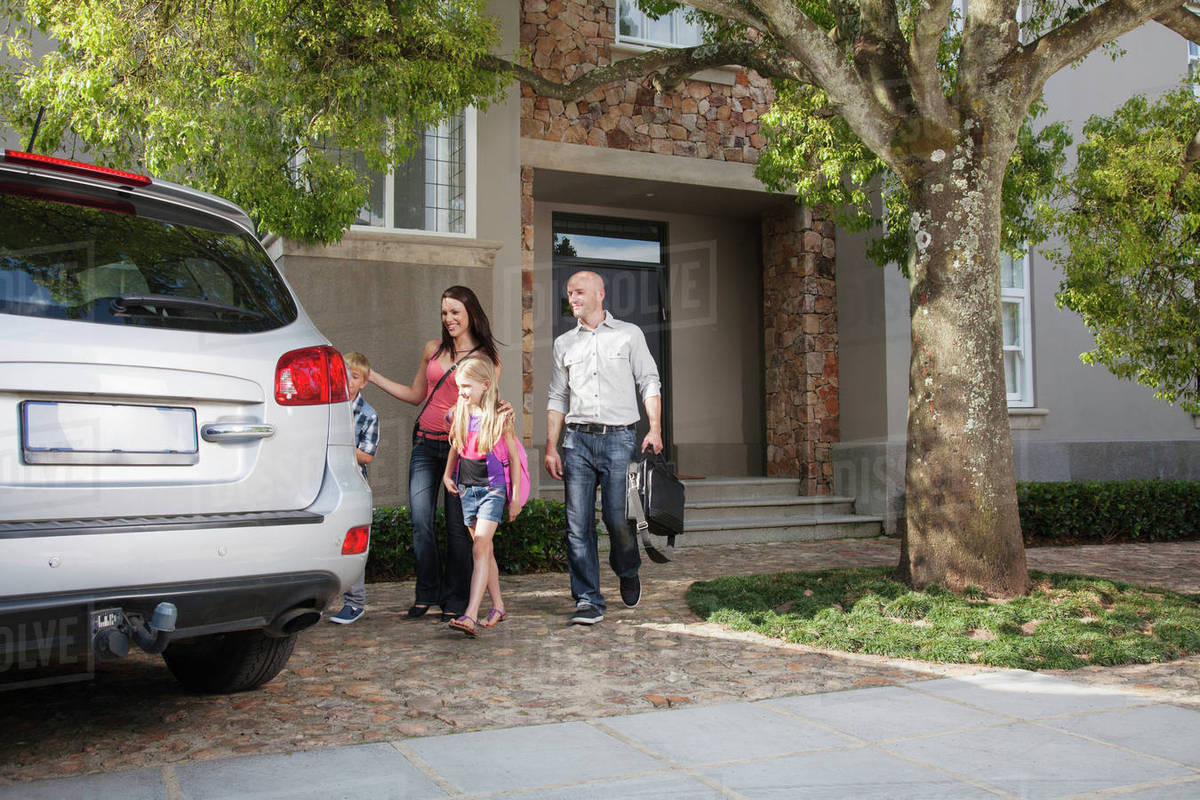 Parents with kids leaving house - Royalty-free Stock Photo | Dissolve