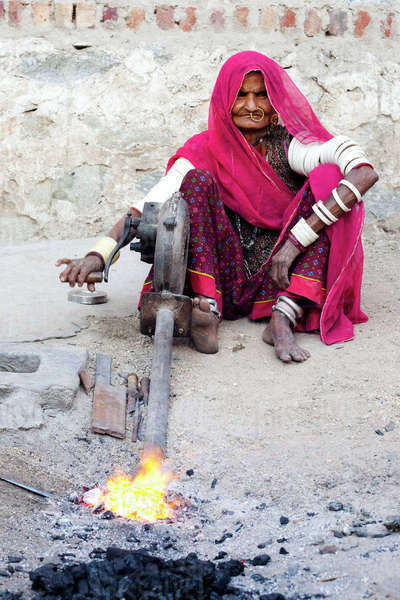 Elderly woman starting a fire, Bisalpur, Uttar Pradesh, India - Stock ...