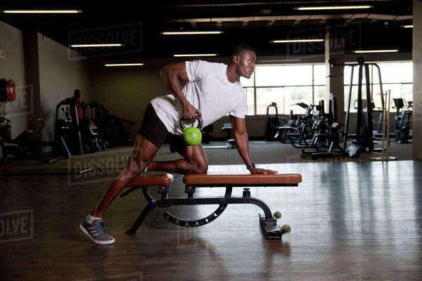 African man lifting a kettlebell - Stock Photo - Dissolve