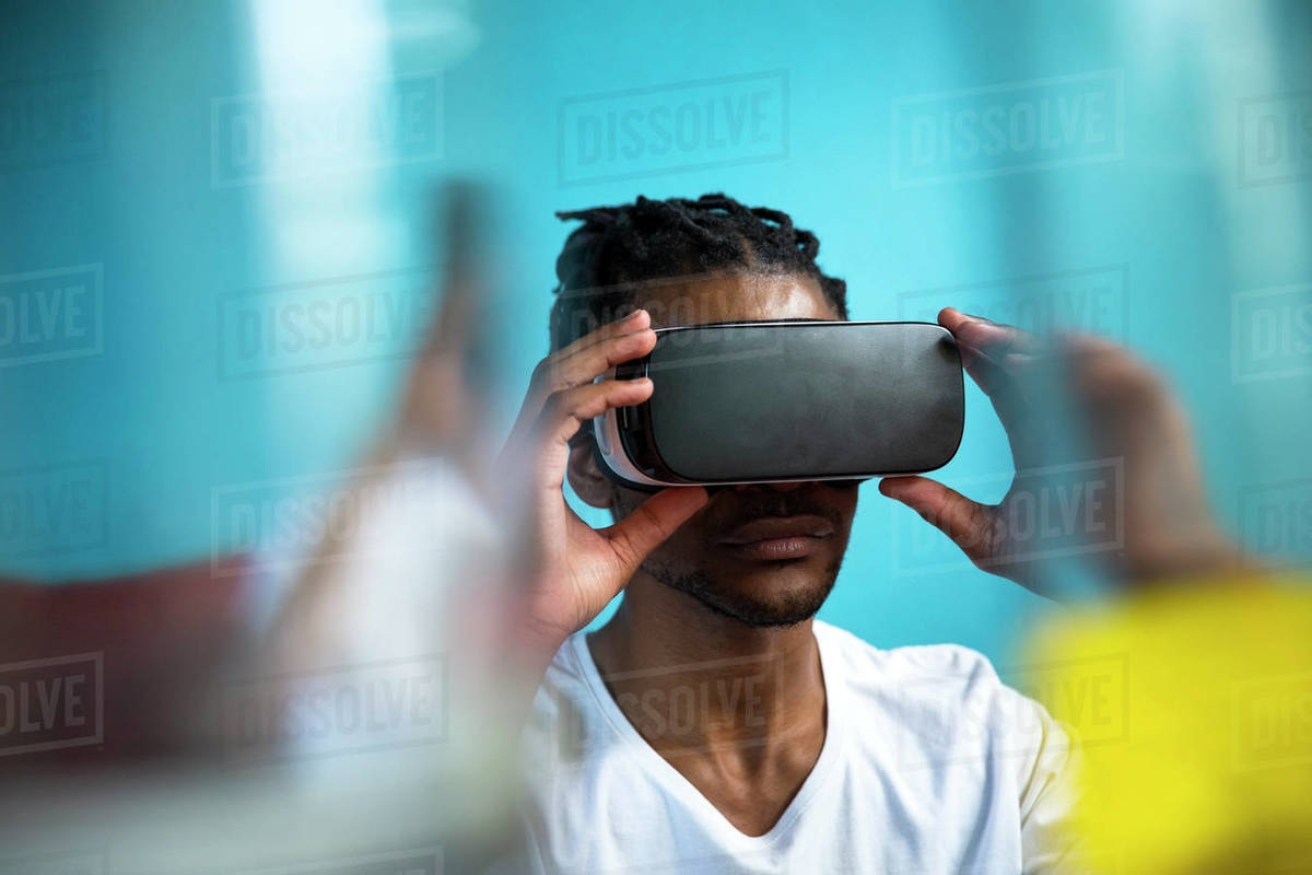African man looking through VR headset - Royalty-free Stock Photo ...