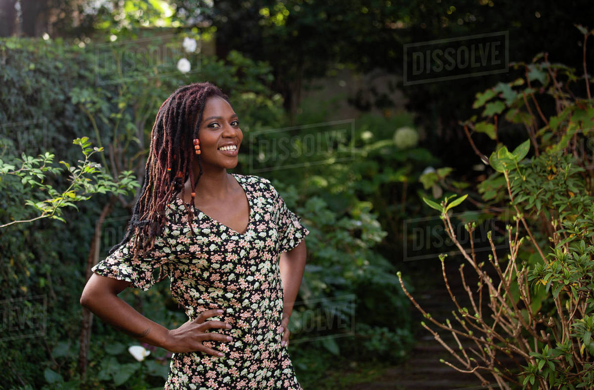 An African woman standing in a garden - Royalty-free Stock Photo | Dissolve
