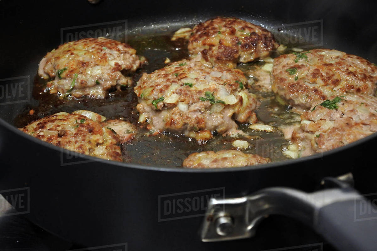Frying beef meat patties in a fry pan. Food background and texture ...