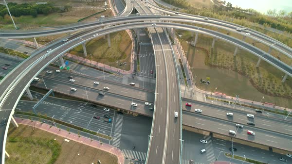 Top view to the cars driving on multi-level highway on the sunset ...