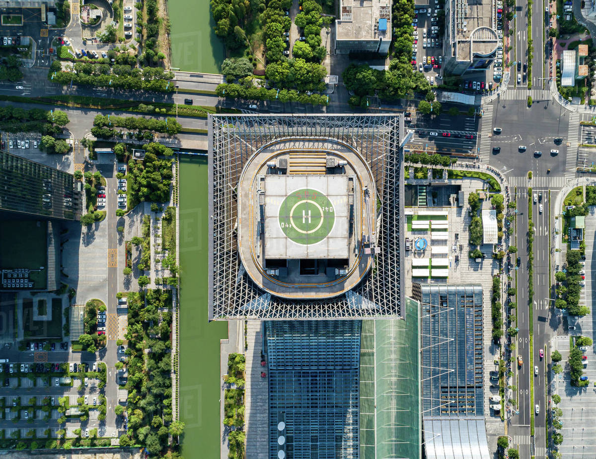 Aerial drone view of helipad on the roof of a skyscraper in downtown ...