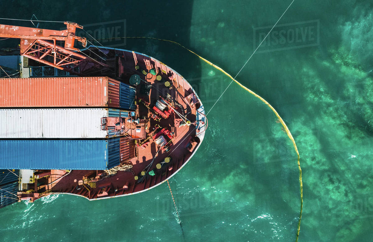 Aerial view of a container cargo ship stands aground after a storm with ...