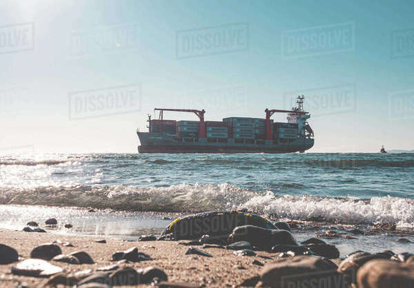 Container cargo ship stands aground after a storm. - Stock Photo - Dissolve