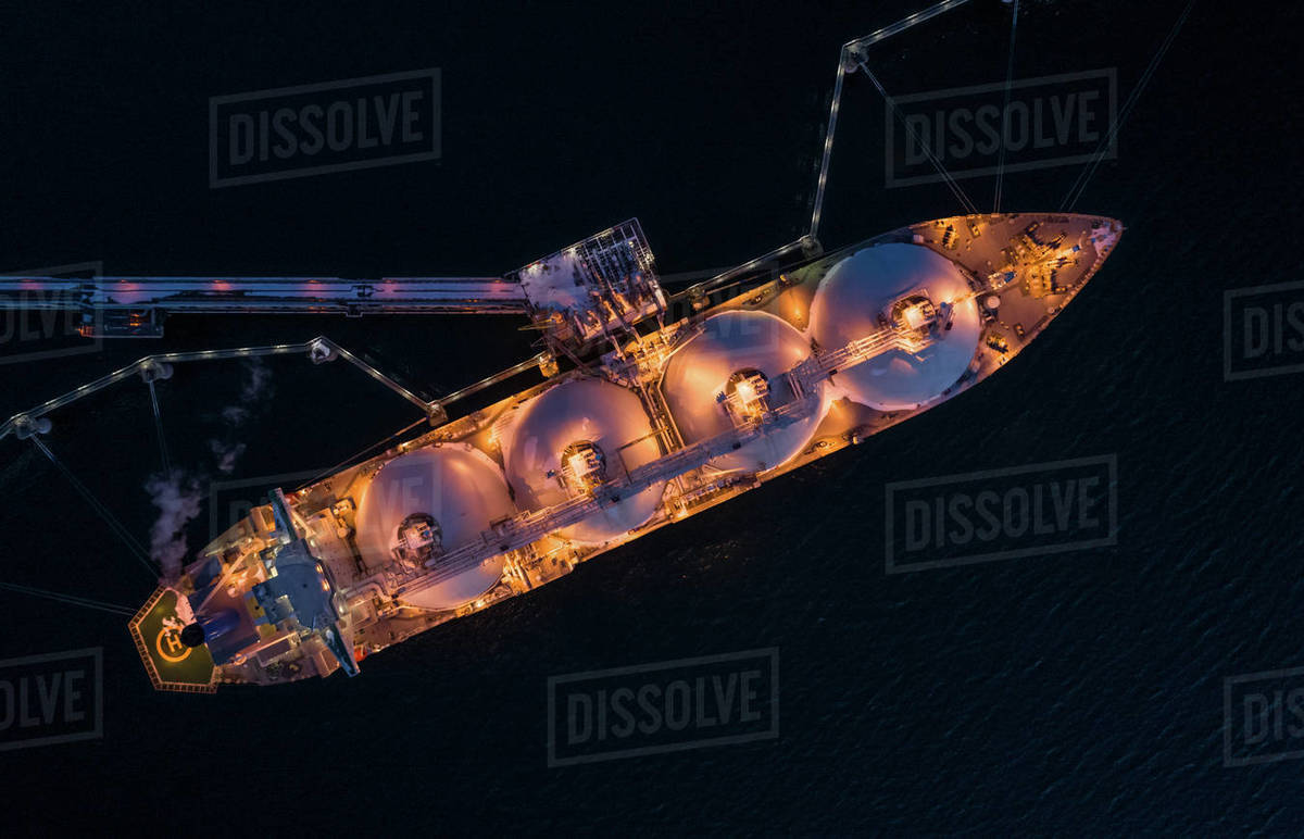 Aerial of Liquified Natural Gas LNG carrier moored to a small gas ...