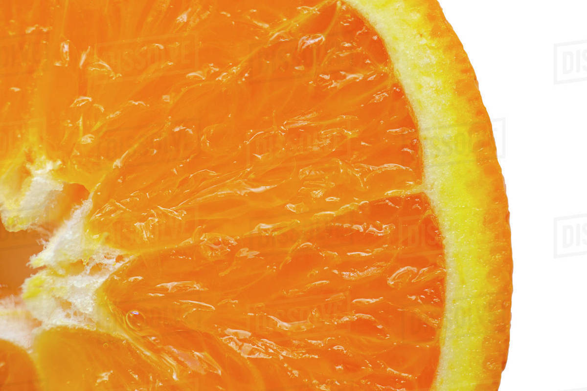 A slice of orange close up. - Royalty-free Stock Photo | Dissolve