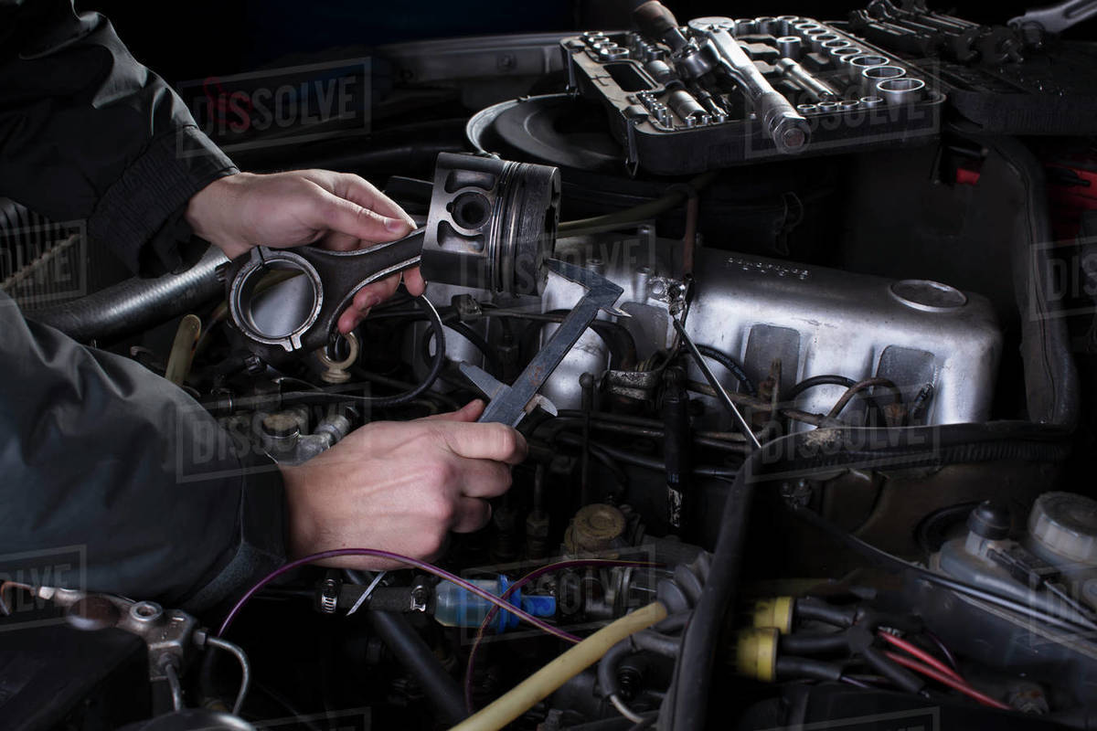 Car engine maintenance. Engine piston system repair. Hands with a ...