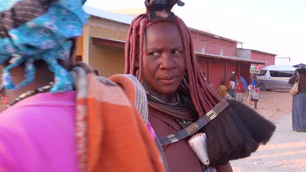 A Himba tribal woman shows off her braided, mud caked, dreadlock hair ...