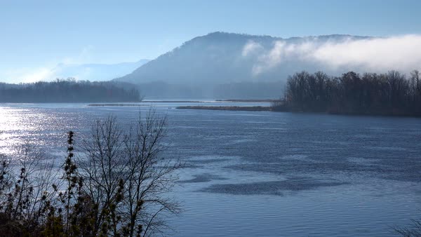 Fog rises along the bluffs of the Mississippi River on the Iowa ...