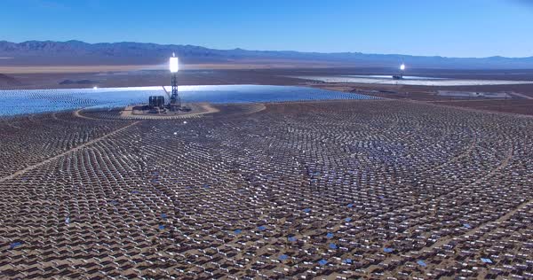 A beautiful aerial over a vast concentrated solar power farm in the ...