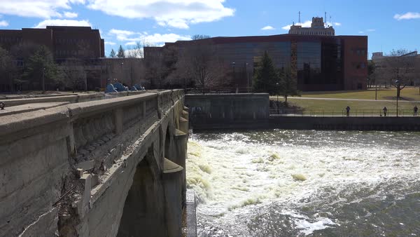 Polluted water flows from the Flint River through Flint, Michigan ...