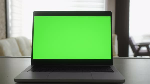 Home office concept. Green screen laptop computer on kitchen island ...