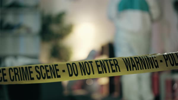 Forensics team working at crime scene, collecting evidence in victim's ...