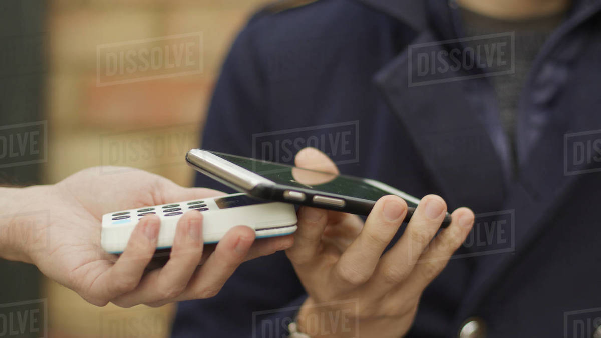 Contactless payment with a smart phone outside venue - Stock Photo ...