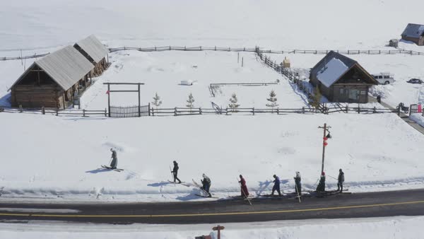 Tuva men dressed in traditional clothing walking in fur ski in snow ...