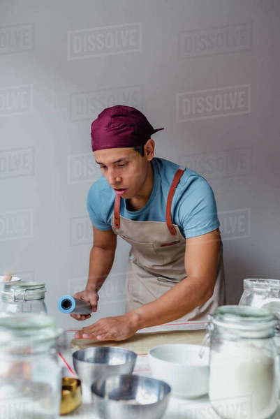 Man kneading dough over a white table. - Royalty-free Stock Photo ...