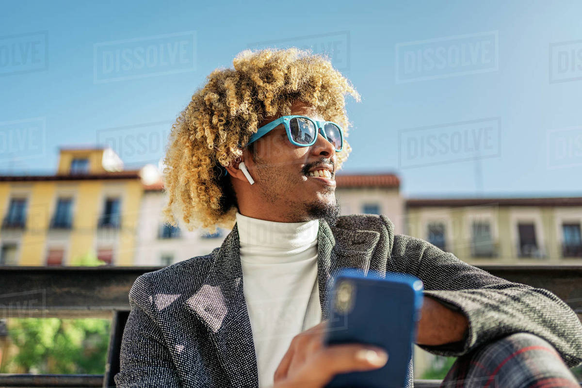 Smart african man listening music using mobile phone at the street - Royalty-free Stock Photo ...