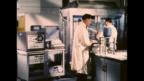 Early 1960s laboratory footage of men testing equipment and control ...