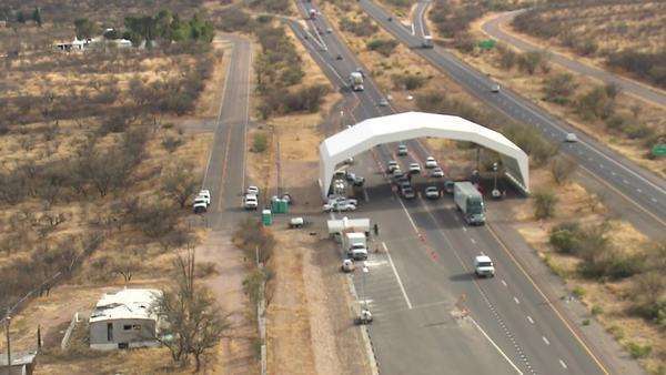 Aerial over a U.S. Border Patrol and Customs checkpoint along a highway ...
