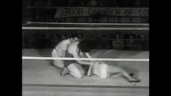 1950s - A female wrestler puts her opponent in a chokehold with her ...