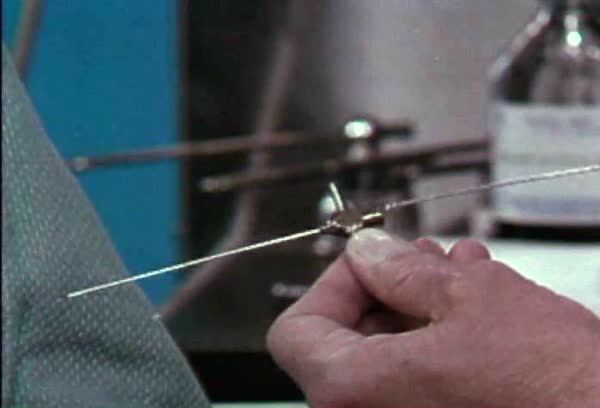 A physician assisted by a technician conduct an antral lavage to clear ...