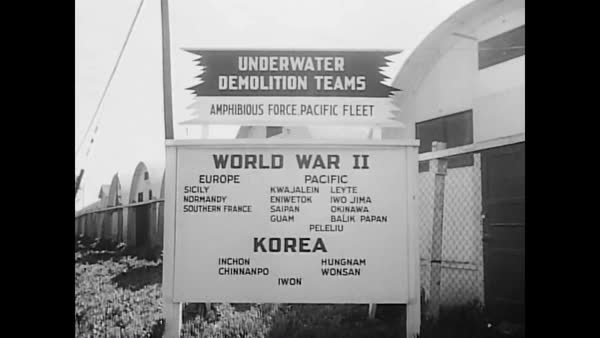 Members of an underwater demolition team emerge from a decompression ...