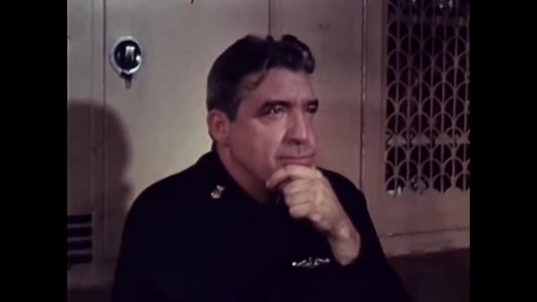 1967 - Actor Chris Bohn speaks as officers play chess aboard a United ...