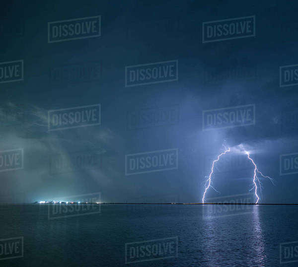 Lightning over water. Electric discharge. Nature background for design ...