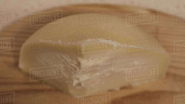 Galician tetilla cheese is cut with a knife by a woman's hands in a ...