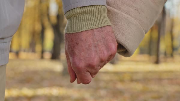 Close up two wrinkled hands elderly couple hold arms together romantic ...