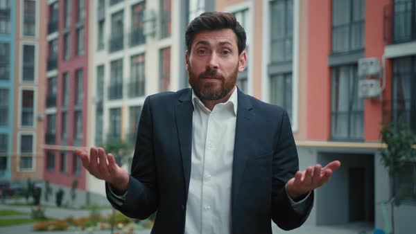 Unsure doubtful businessman stand on city downtown street shrugging ...