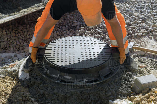 Installing cast iron sewer hatch on a concrete base of installation of ...