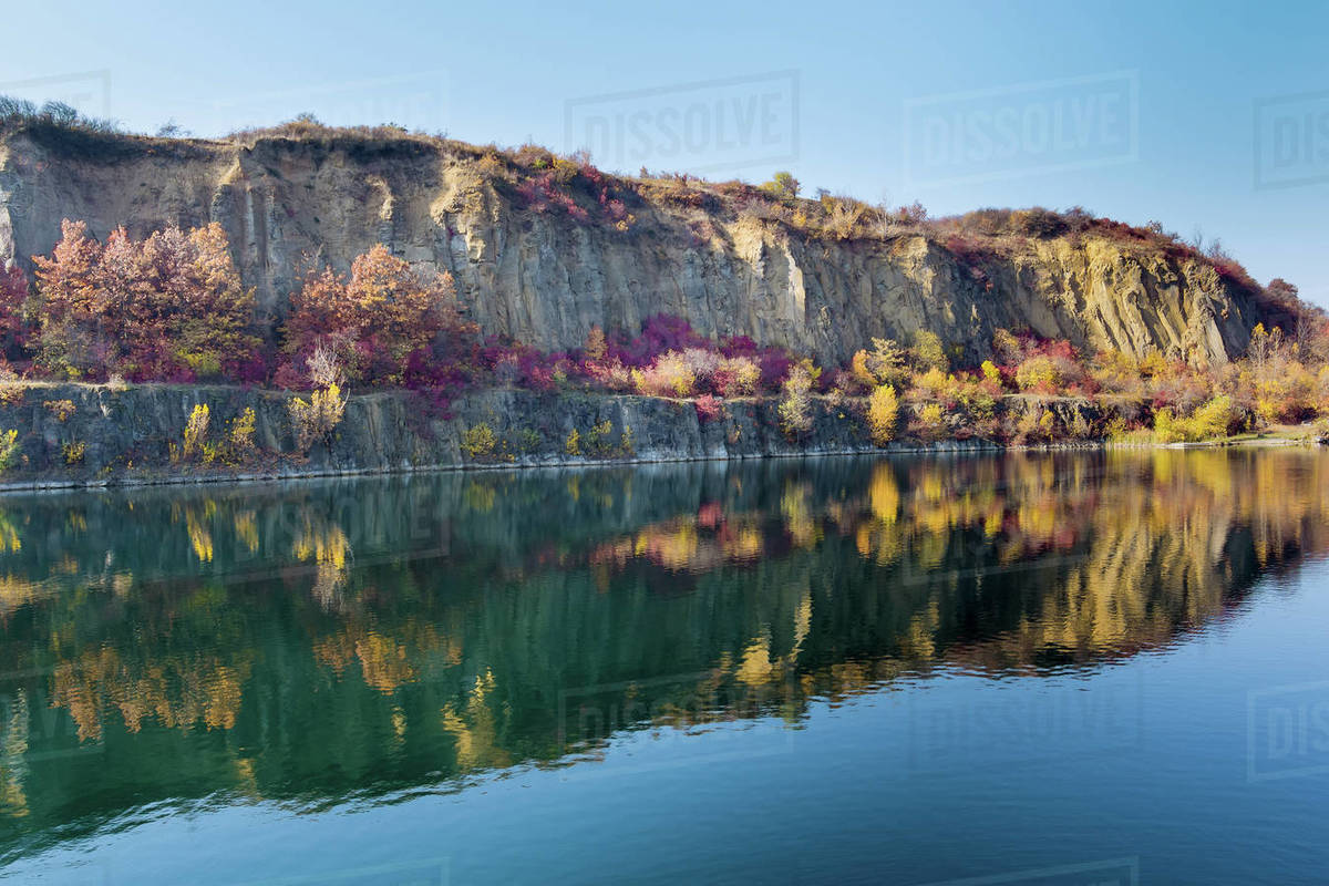 Aerial top view an quarry pond formed during mining stone with ...