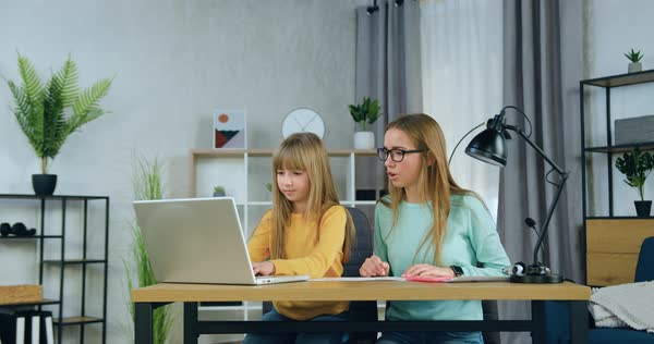Adorable confident friendly two different ages sisters sitting in front ...