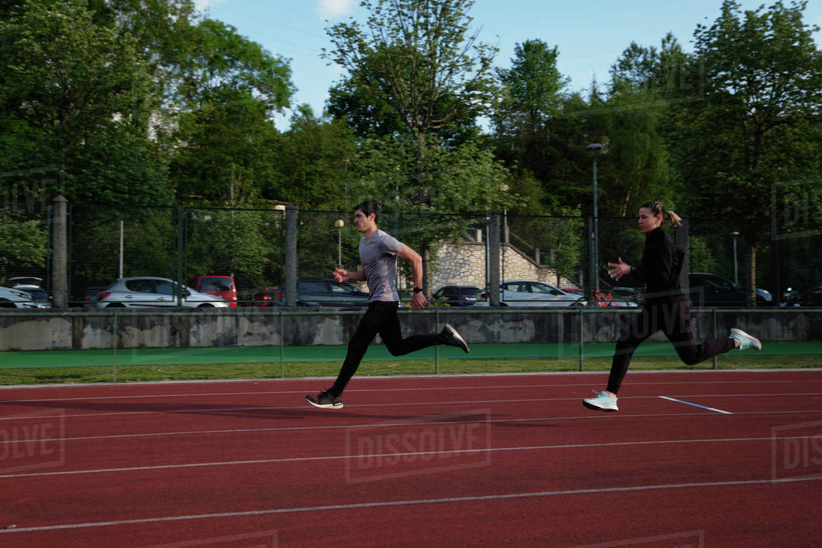 two young adult athletes competing against each other to win a friendly ...