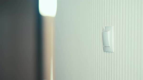 Woman leaves the room and turns off the light switch, close up - 4K ...