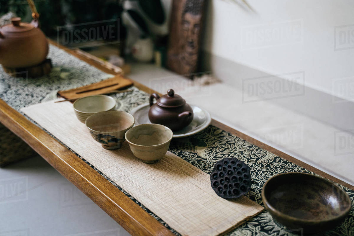 Girl is making a tea ceremony for her friends - Stock Photo - Dissolve