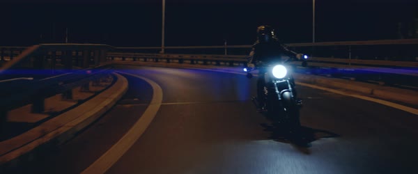 TRACKING Shot of a biker riding his custom built cafe racer motorcycle ...