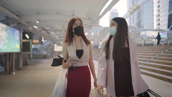 Asian colleagues office worker walking home after work using public ...