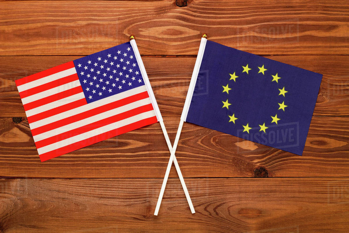 Flag of USA and flag of European Union crossed with each other. USA vs ...