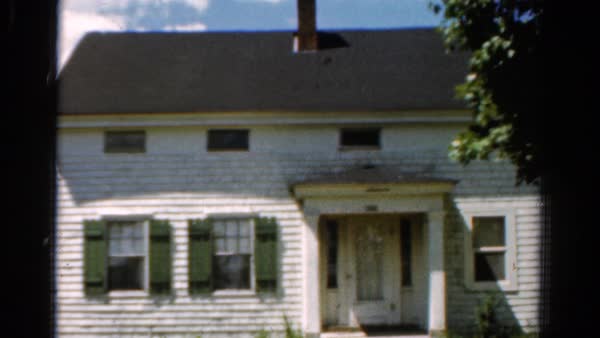 1954: a two-story home with distressed siding and shutters - Stock ...
