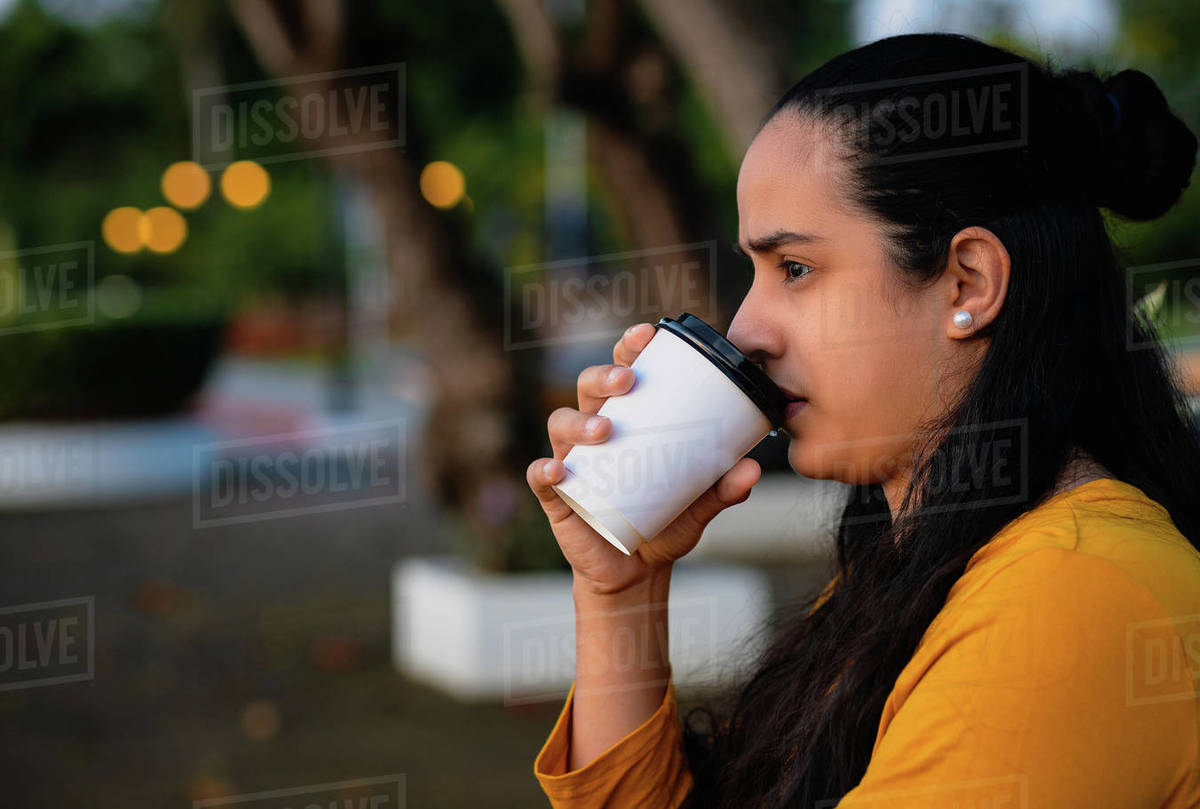 woman sitting drinking coffee in the park - Royalty-free Stock Photo ...
